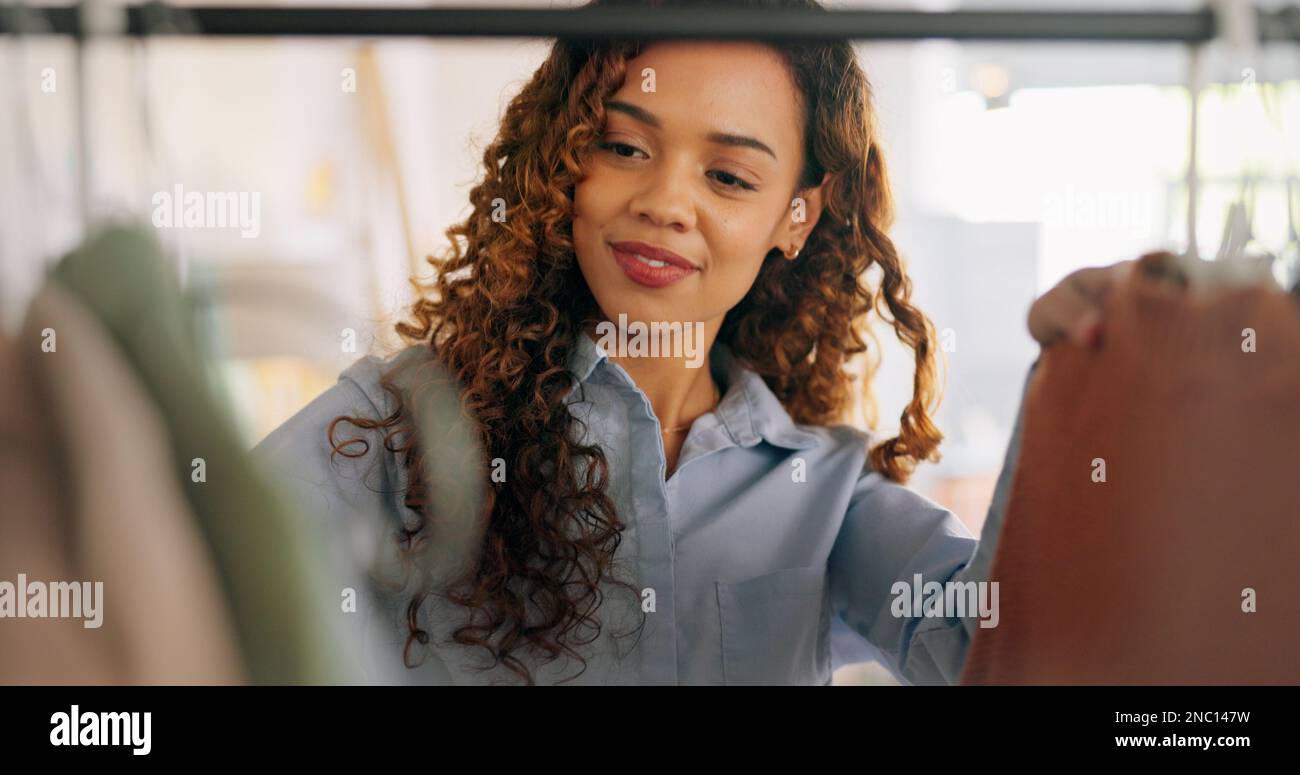 Woman designer, entrepreneur startup and clothes rack in modern ...