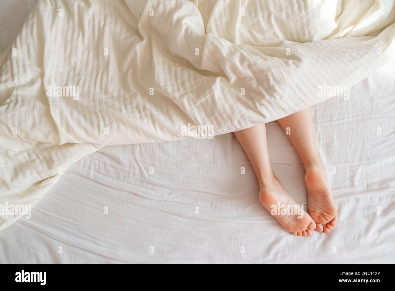 Woman sleeps up legs hi-res stock photography and images - Alamy
