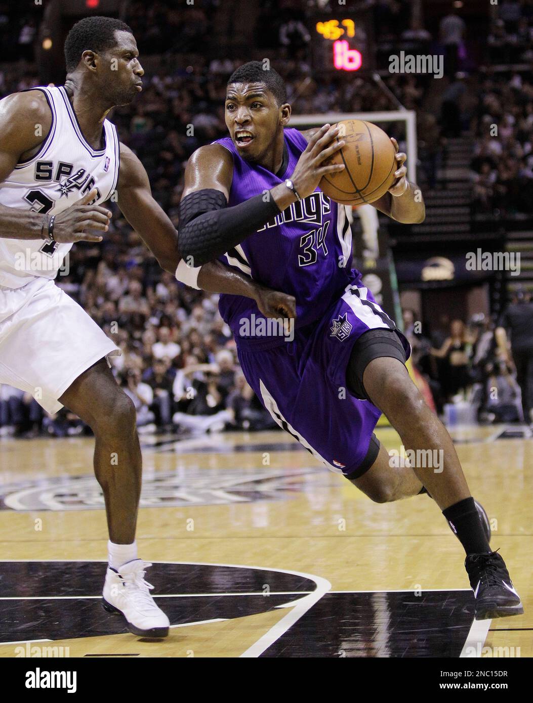 Sacramento Kings' Jason Thompson, right, drives past San Antonio Spurs ...