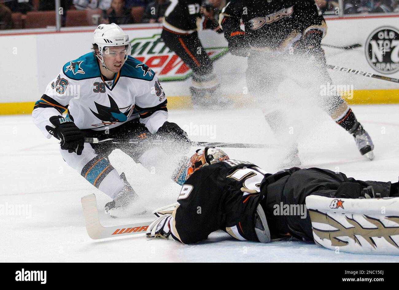 San Jose Sharks center Logan Couture, left, watches as Anaheim Ducks ...