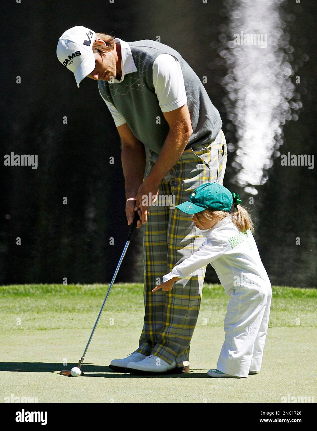 Aaron Baddeley of Australia's daughter Jewel points at his ball before ...