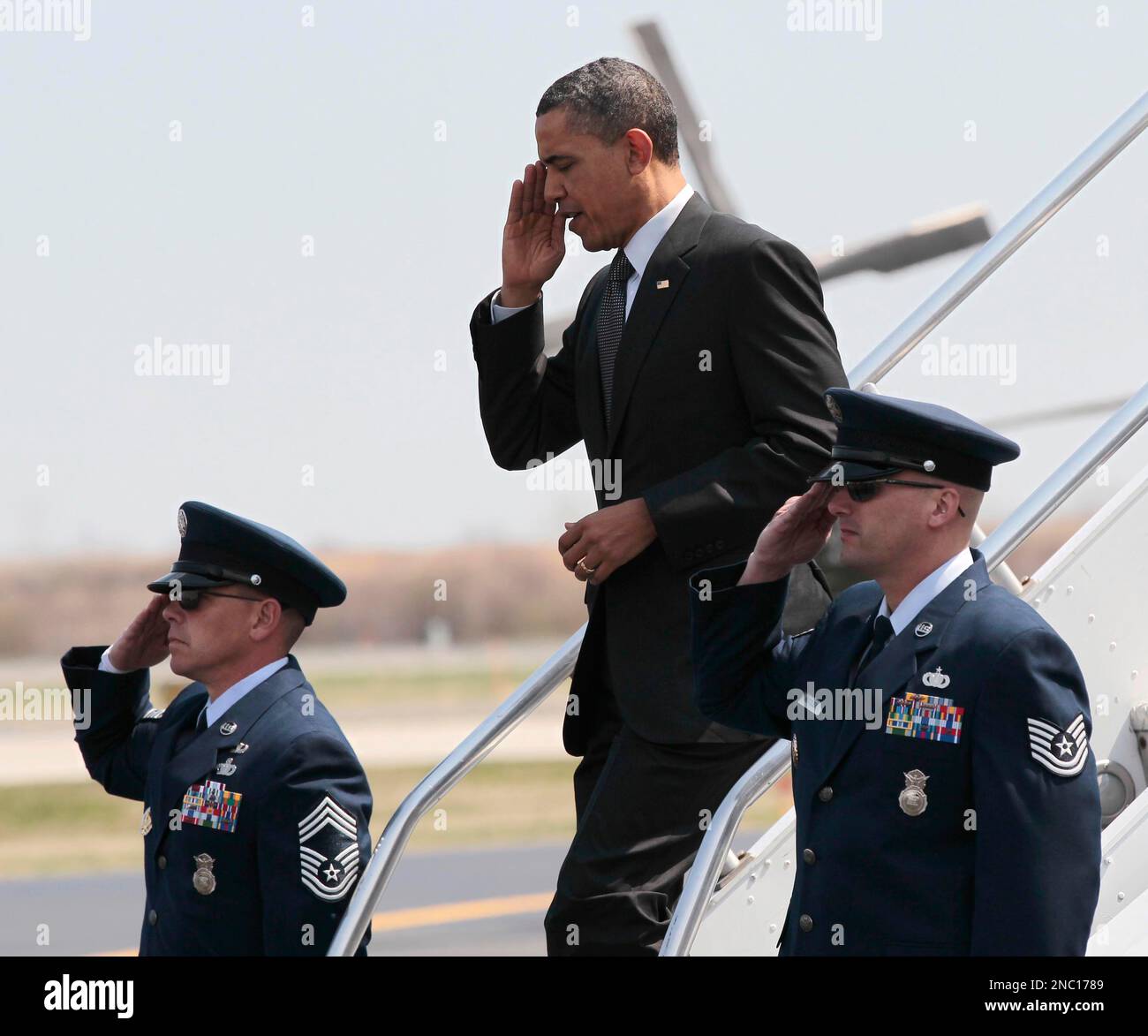 President Barack Obama salutes as he walks down the steps of Air Force ...