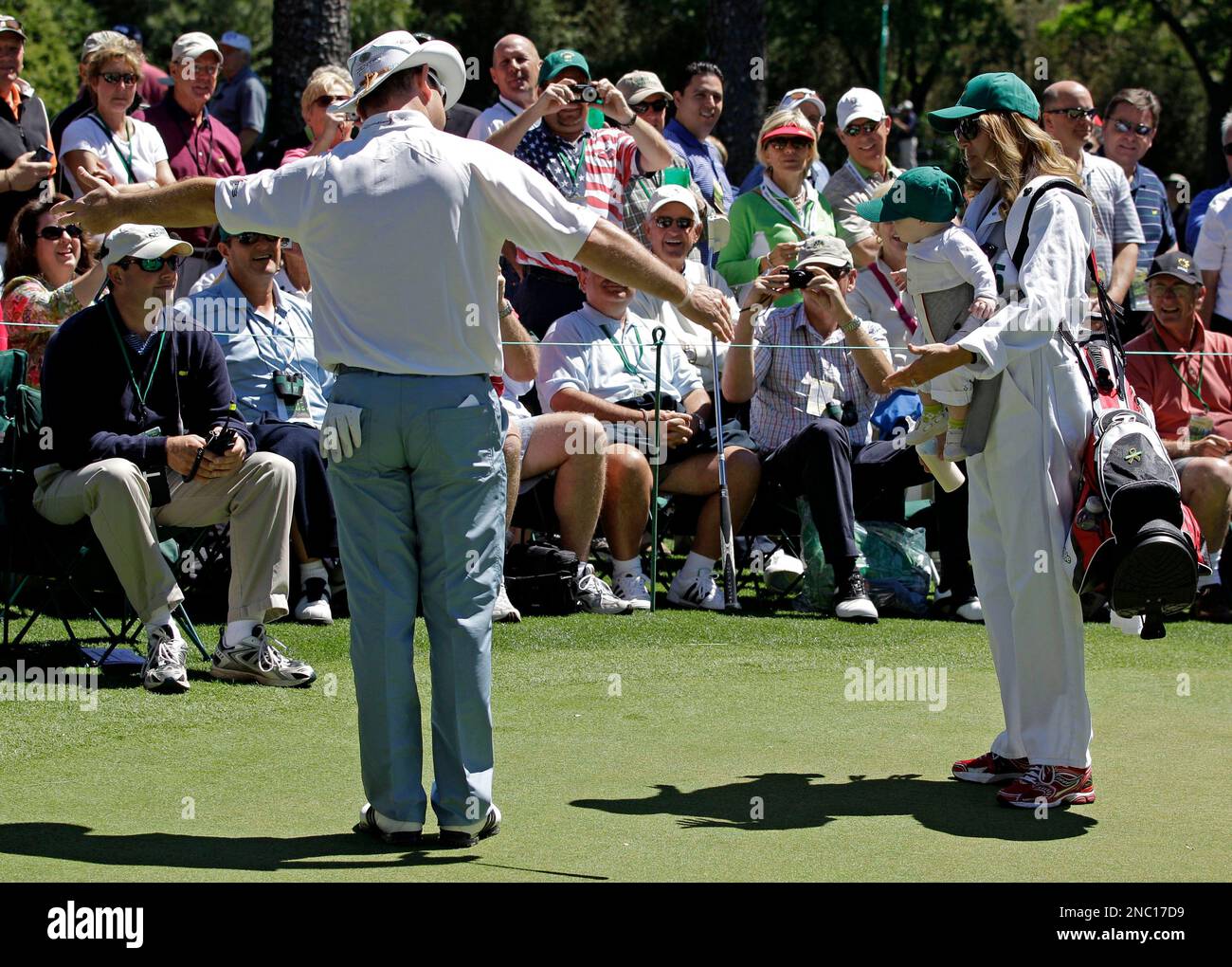 Rory Sabbatini of South Africa waits for his wife Amy and carrying ...