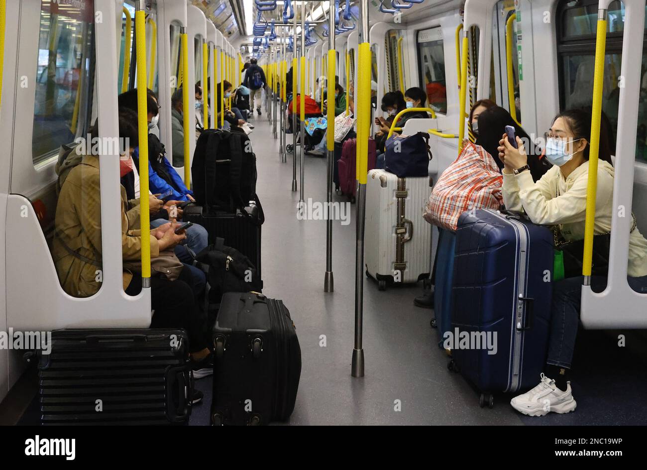 Passengers on a East Rail Line train heading to the Lok Ma Chau border ...