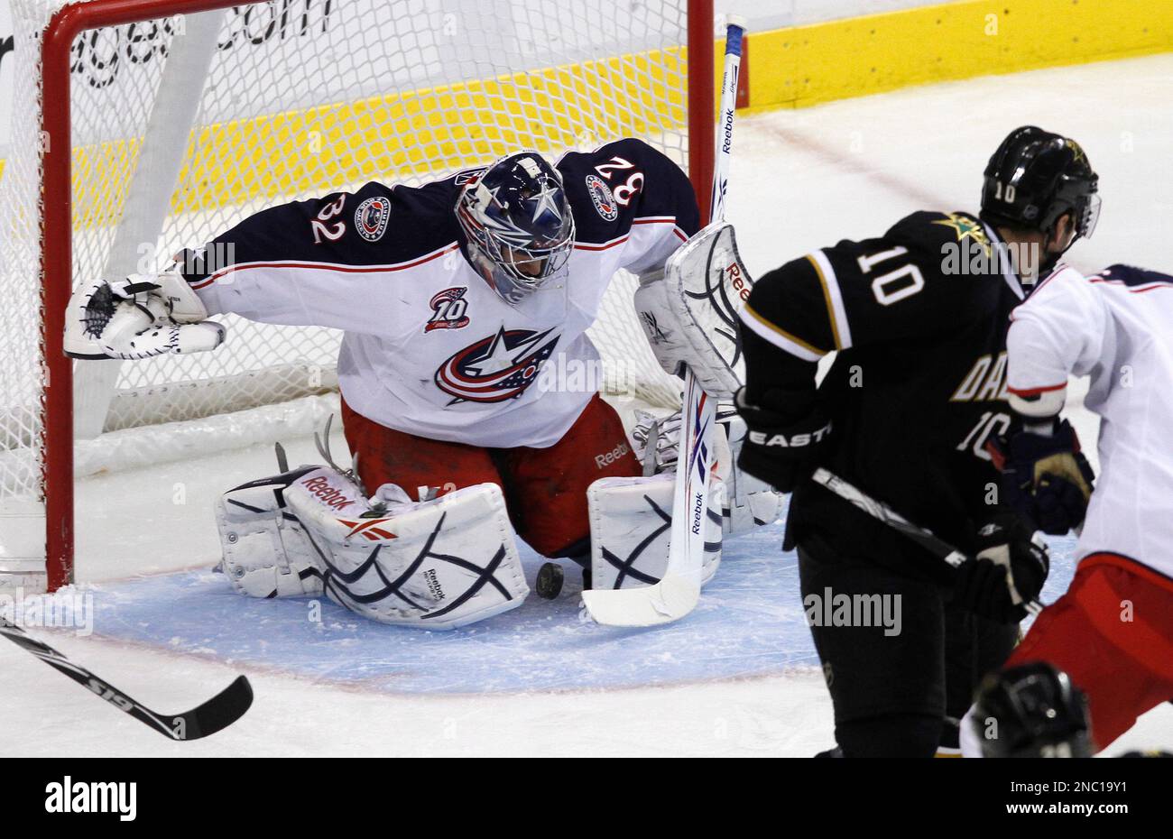 Columbus Blue Jackets goalie Mathieu Garon (32) stops the puck between ...