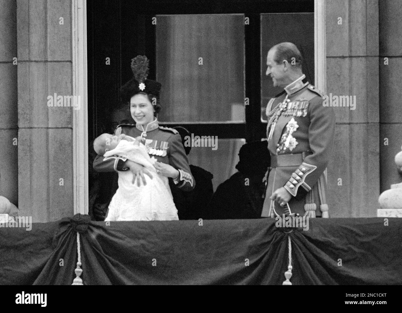 Wearing the scarlet tunic of the Grenadiers, Queen Elizabeth II holds ...