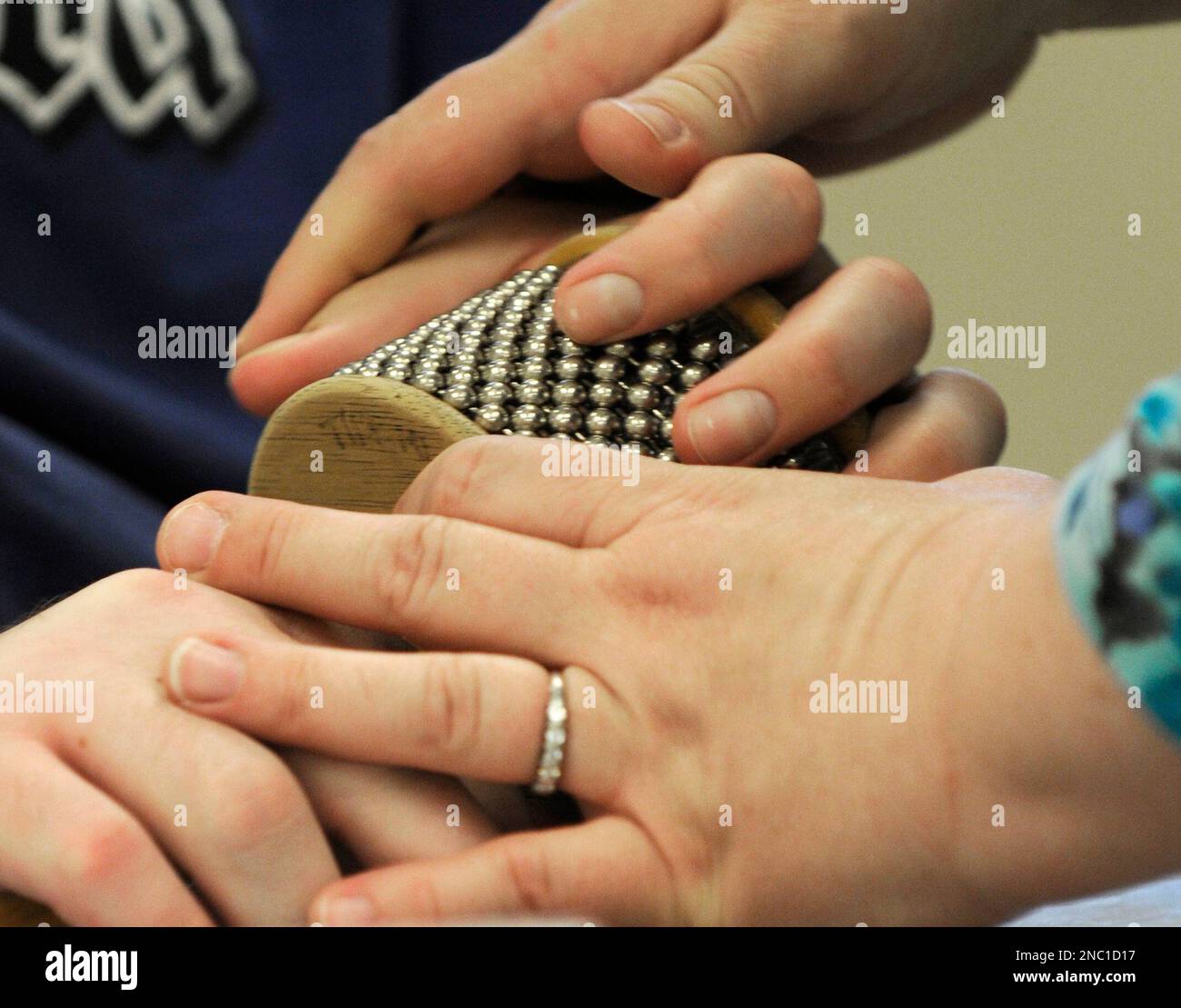 In this March 25, 2011 photo, music therapist Amy Culpepper wraps a ...
