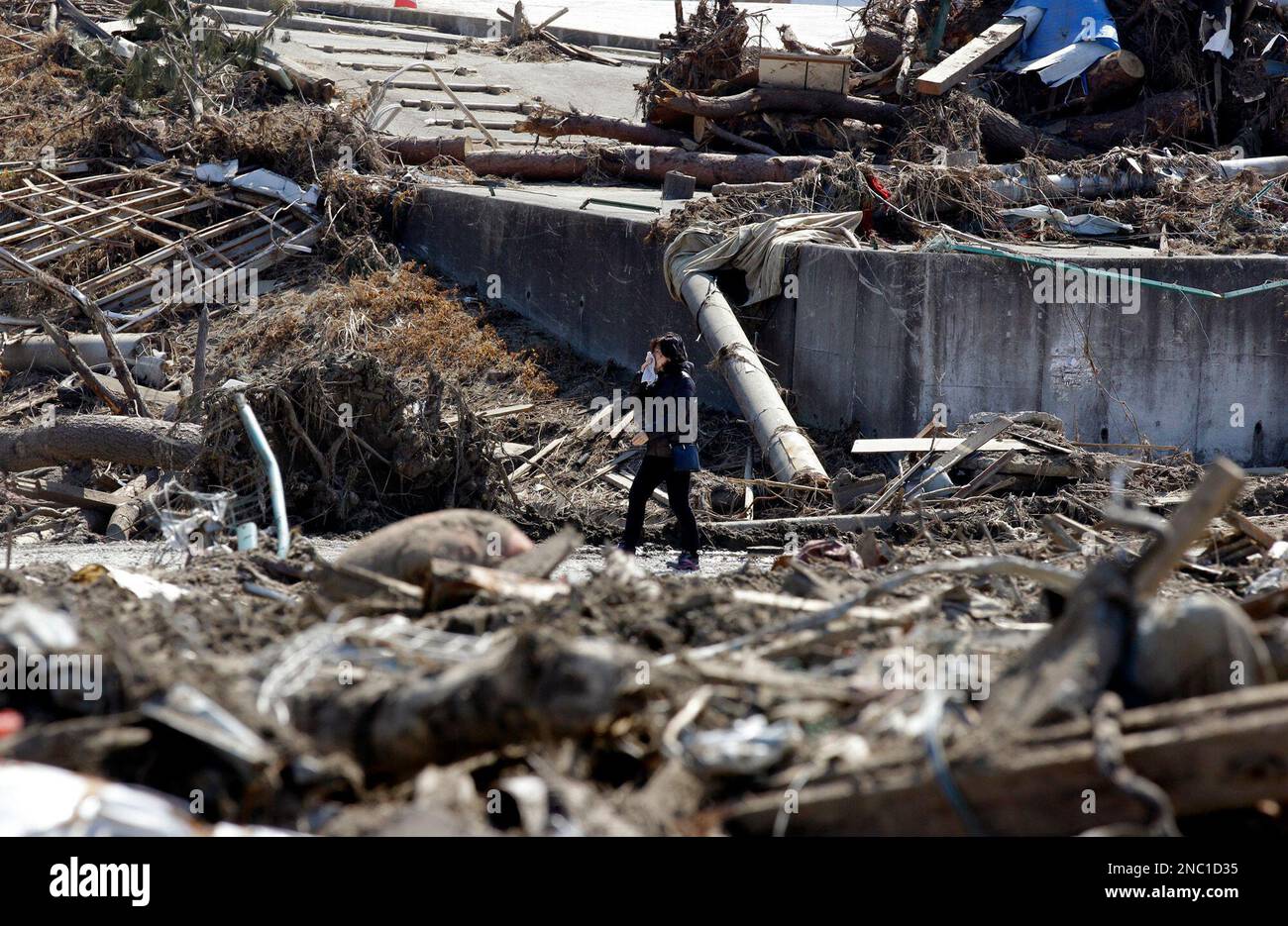 A survivor walks at the Okawa elementary school devastated by a ...