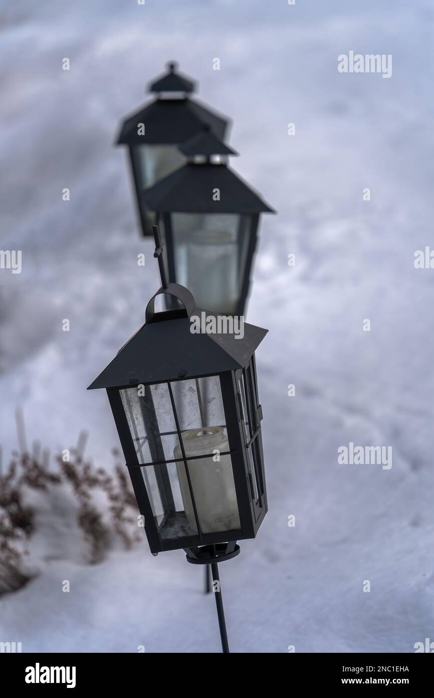Grave lanterns on snow in the cemetery in winter, close up Stock Photo - Alamy