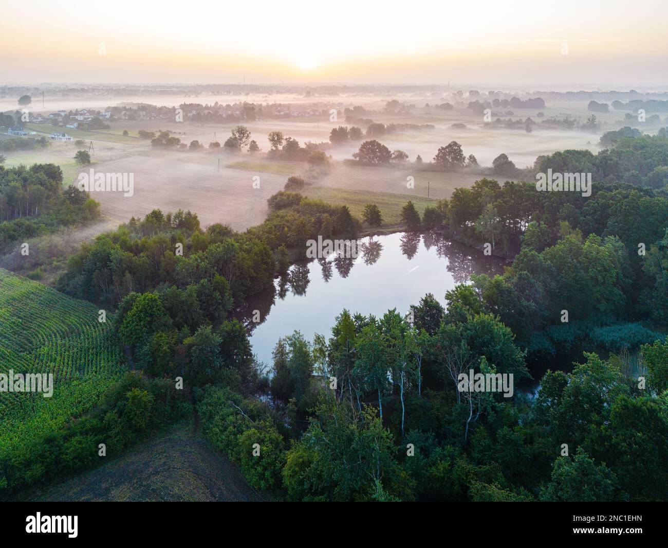 An aerial view of rural countryside with rolling hills and foggy ...