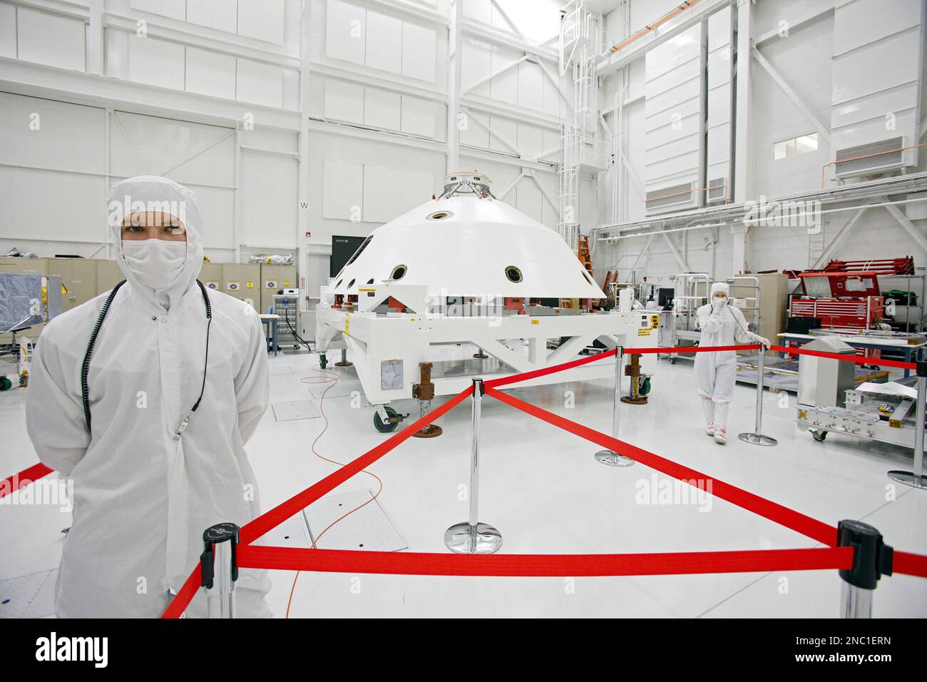 NASA engineers stand by Mars Science Laboratory's aeroshell, a conical ...