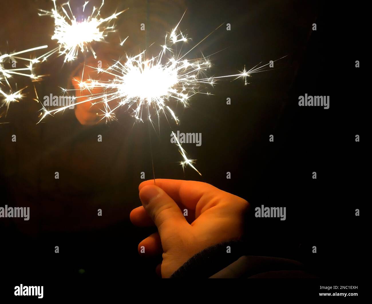 Hand-lit fireworks for New Year's Eve Stock Photo - Alamy