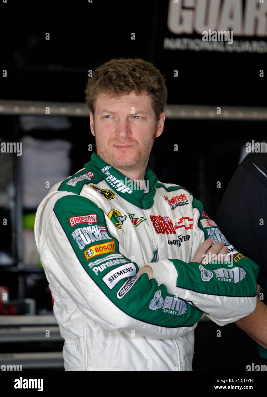 NASCAR driver Dale Earnhardt Jr. during looks out from his garage ...