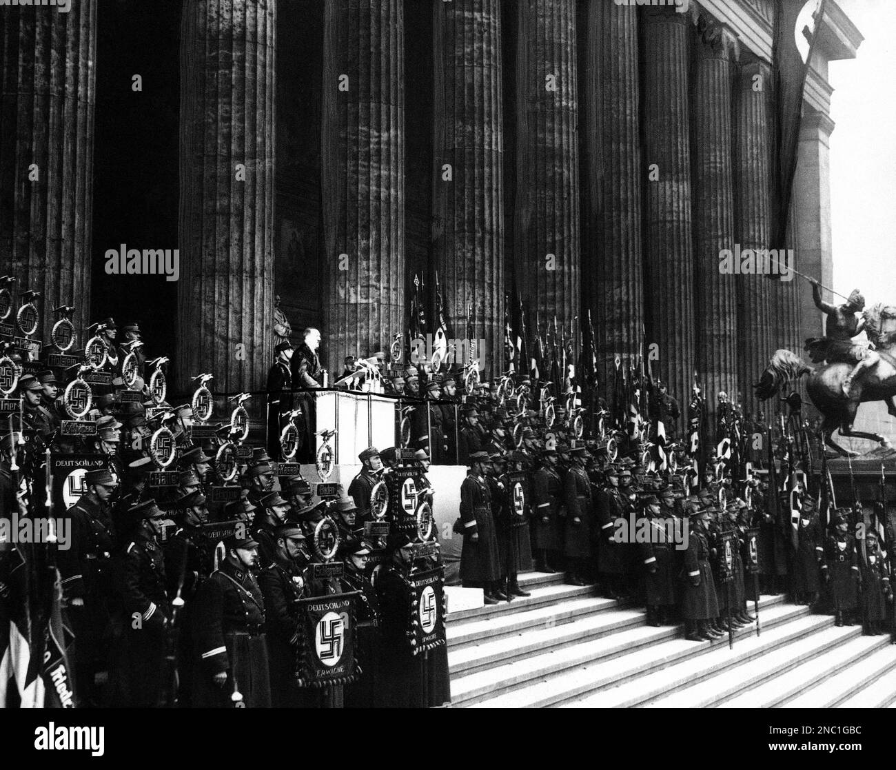Flanked by Nazi banners, Adolph Hitler addresses 25,000 of his old ...