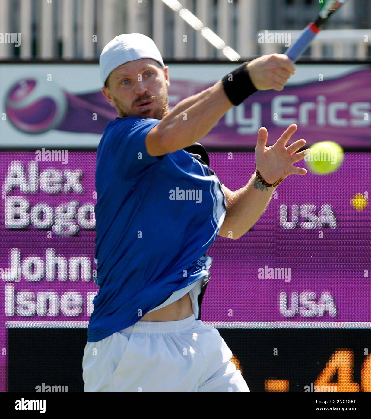 Alex Bogomolov returns to John Isner at the Sony Ericsson Open tennis ...