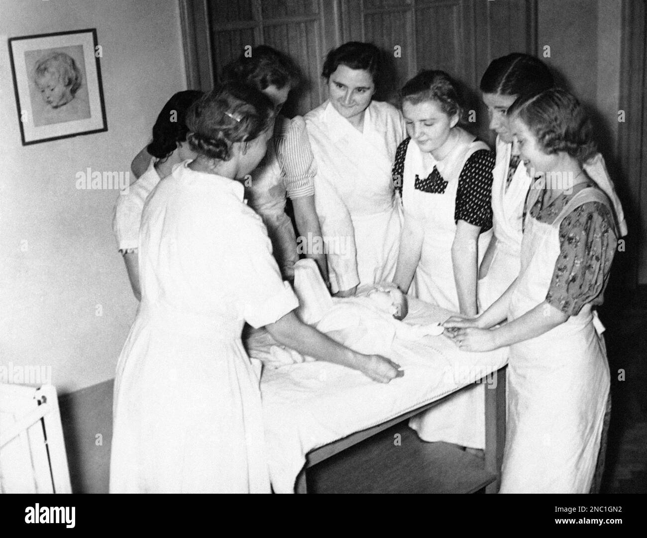 Pupils of the German "School for Brides" learn how to handle a baby ...