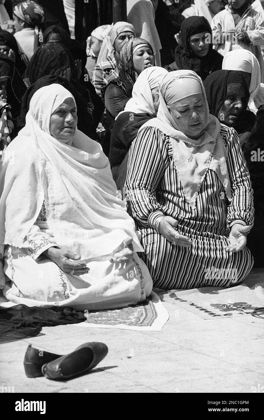 Egyptian Muslim women, dressed in traditional attire, offer prayers at ...