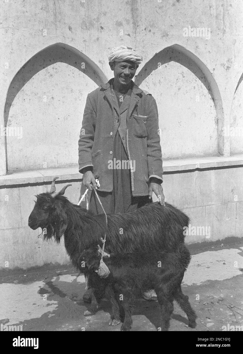 A man poses with a goat in this street scene of old Kabul, Afghanistan ...