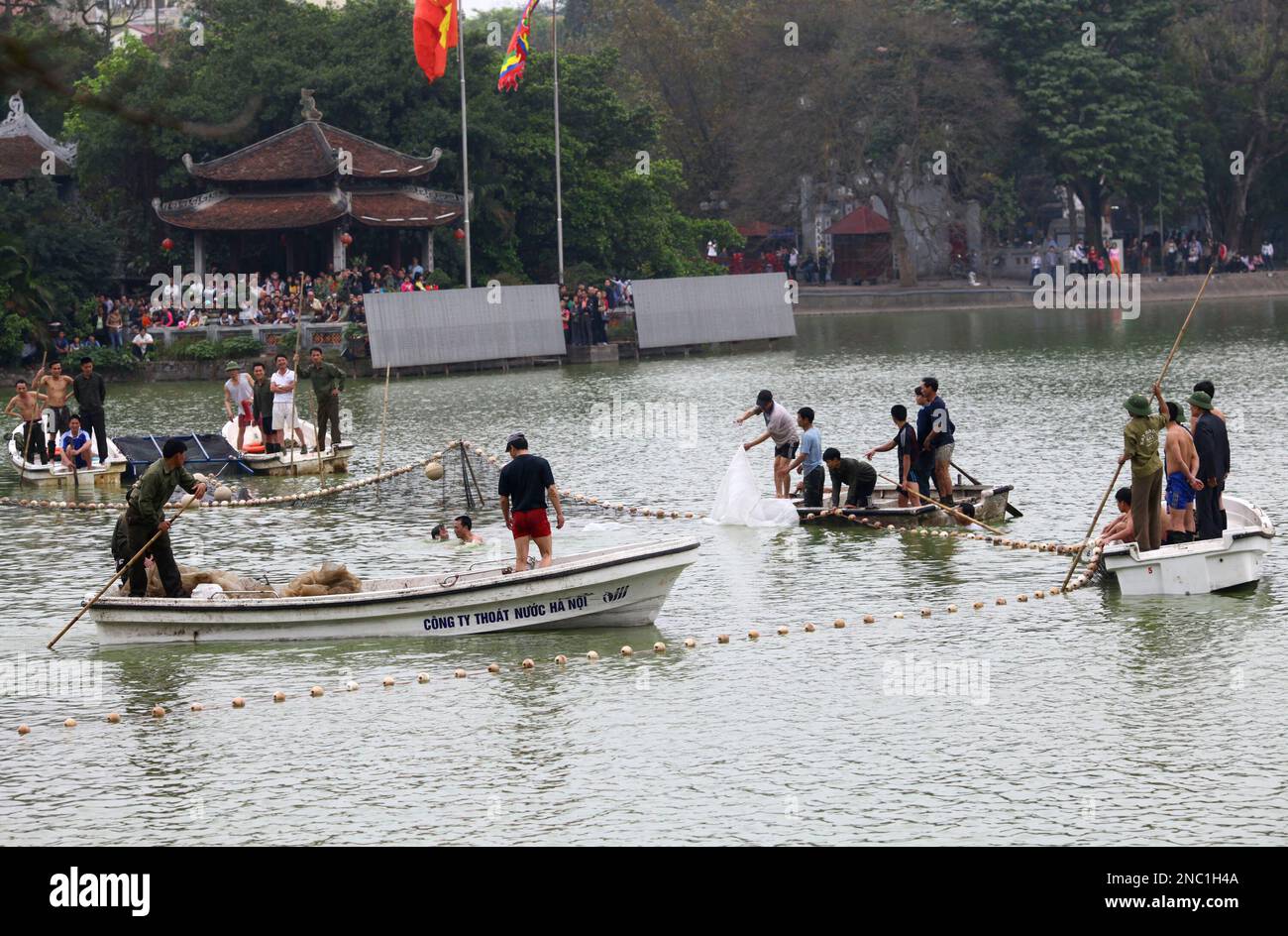 In this photo taken Sunday, April 3, 2011, workers at Hoan Kiem Lake ...