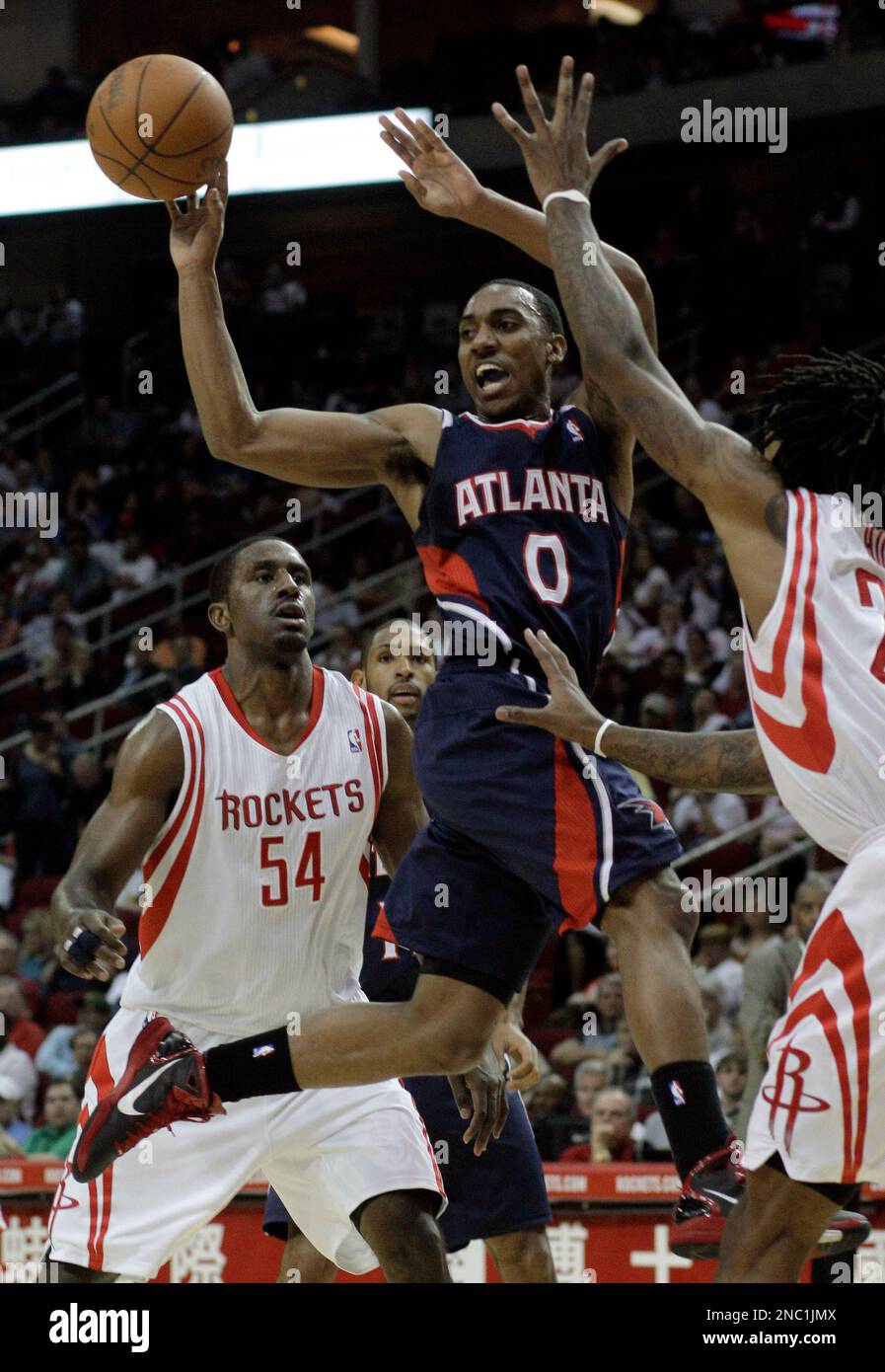 Atlanta Hawks' Jeff Teague (0) goes up between Houston Rockets' Patrick ...