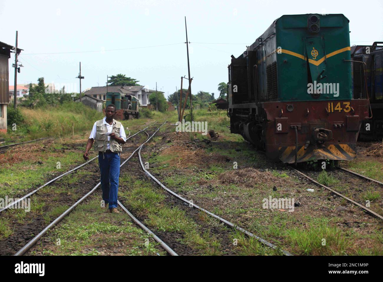 In this Friday, March 11, 2011 photo, a man walks inbetween tracks past ...