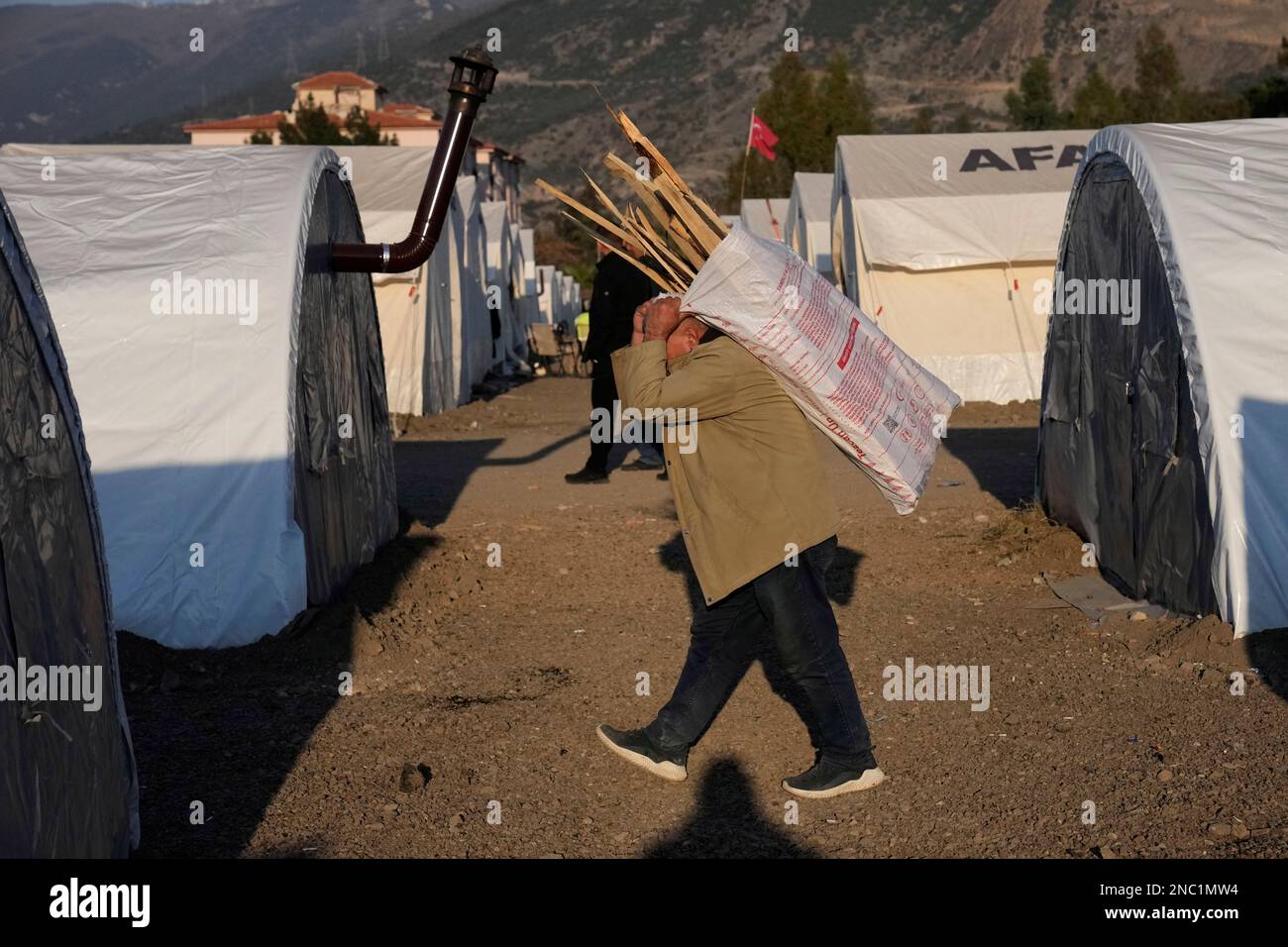 A Turkish man who lost his house in the devastating earthquake, carries ...