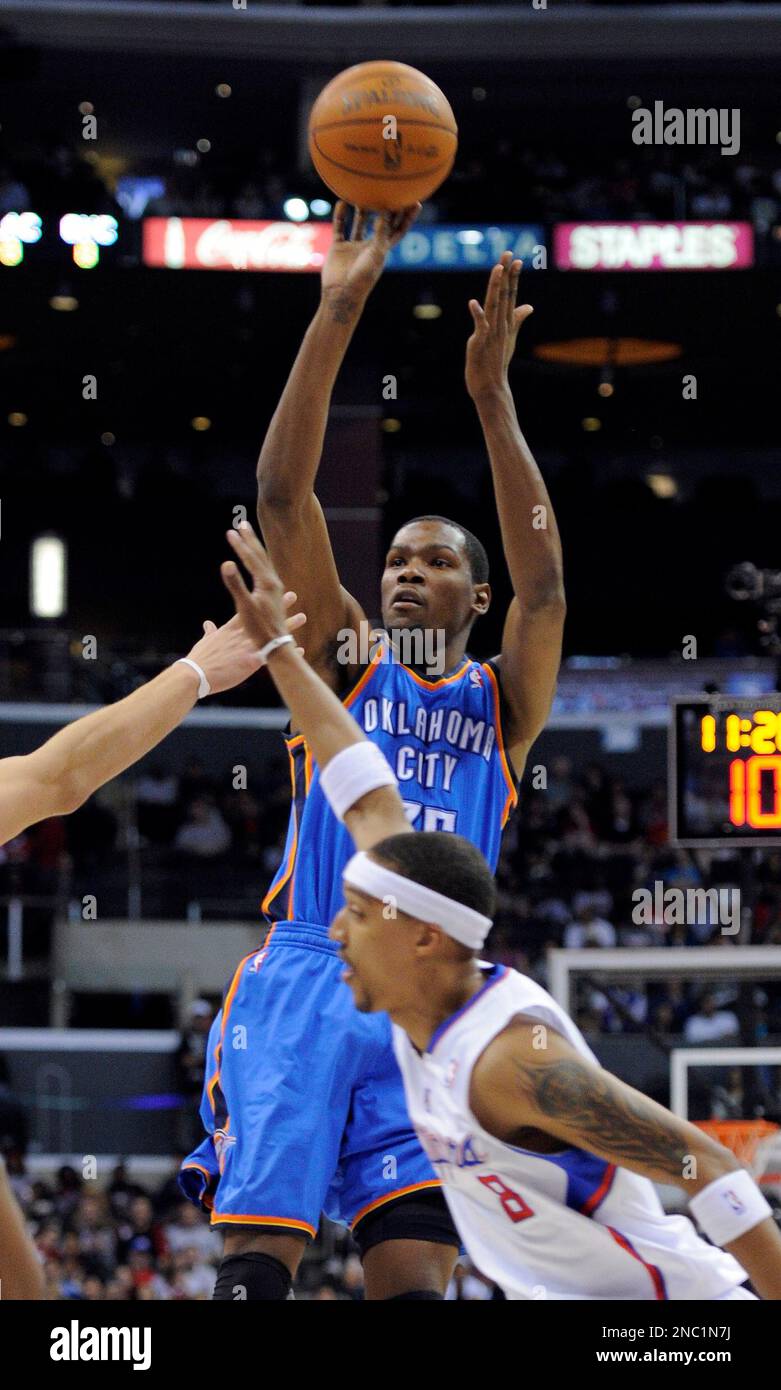 Oklahoma City Thunder forward Kevin Durant, top, puts up a shot as Los ...