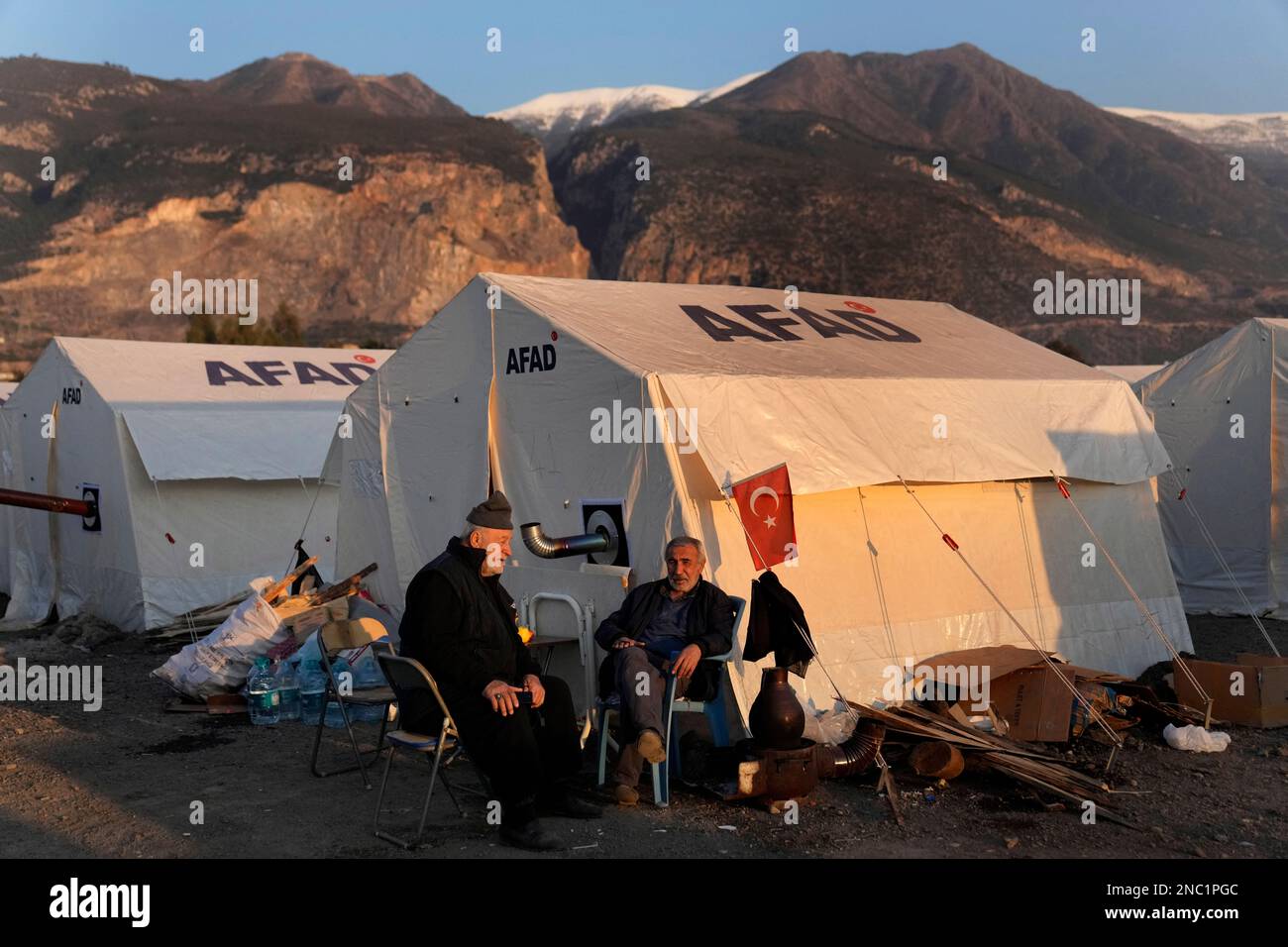 People who lost their houses in the devastating earthquake, sit outside ...