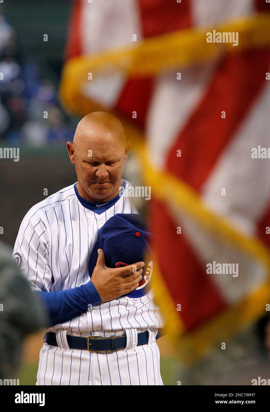 Chicago Cubs manager Mike Quade places his cap over his heart, before a ...