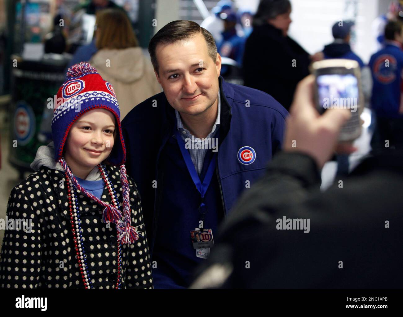 Chicago Cubs' Chairman Tom Ricketts, right, poses for a photo with a ...