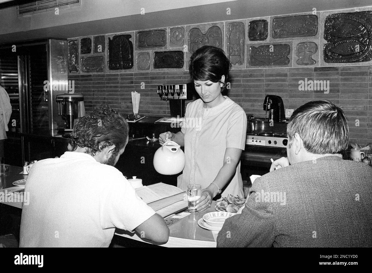 38-year-old Doreya Sharaf, helping customers chose their menu orders at the Hilton coffee shop ...