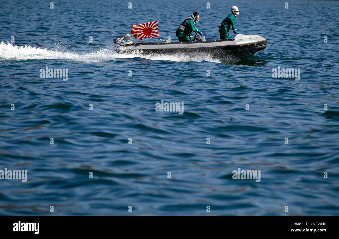 Members of the Japan Maritime Self-Defense Force search for the victims ...