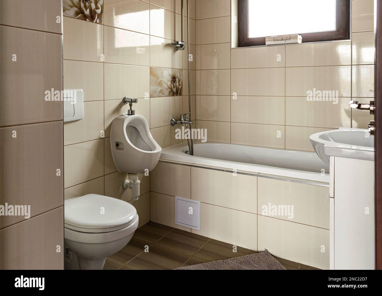 A minimalistic interior of a conjoined white bathroom and toilet Stock ...
