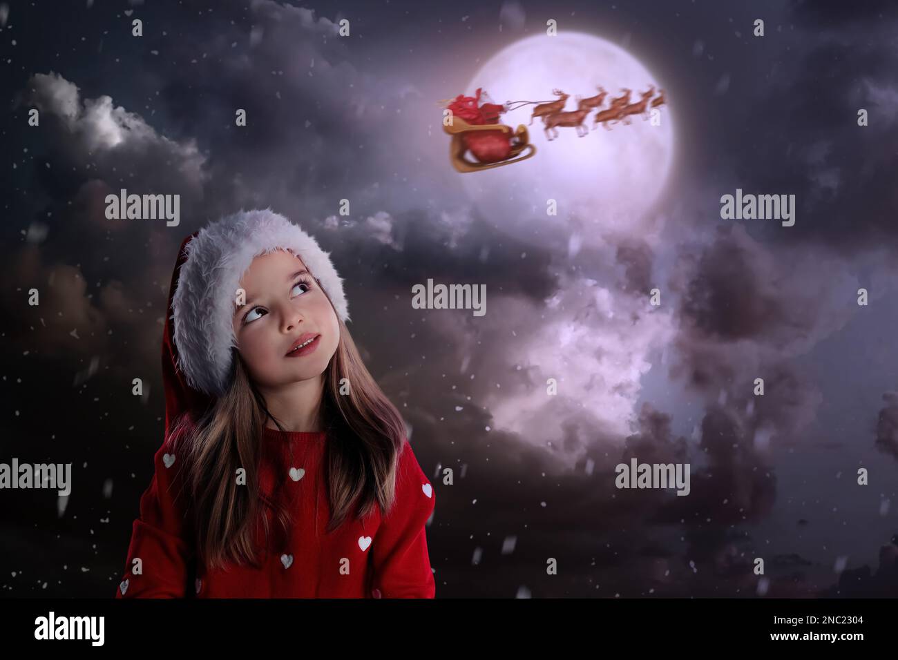 Cute little child and Santa Claus flying in his sleigh on background ...