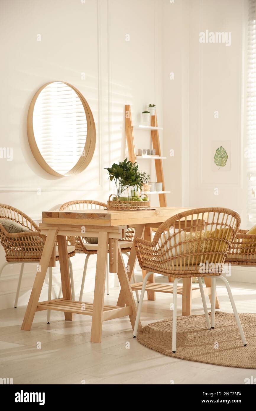 Stylish wooden dining table and chairs in room. Interior design Stock ...