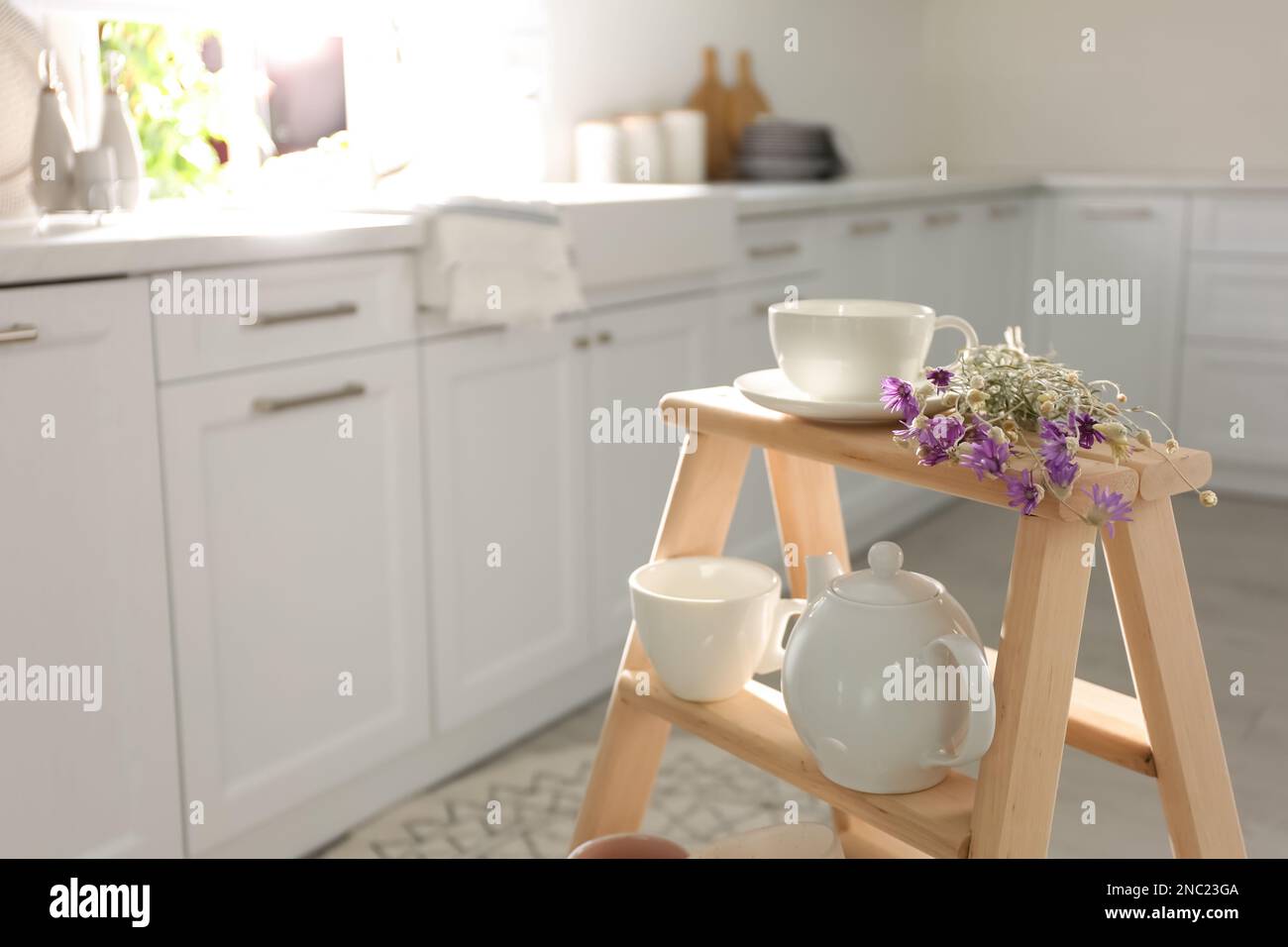 Decorative ladder with different dishware in kitchen. Idea for interior ...