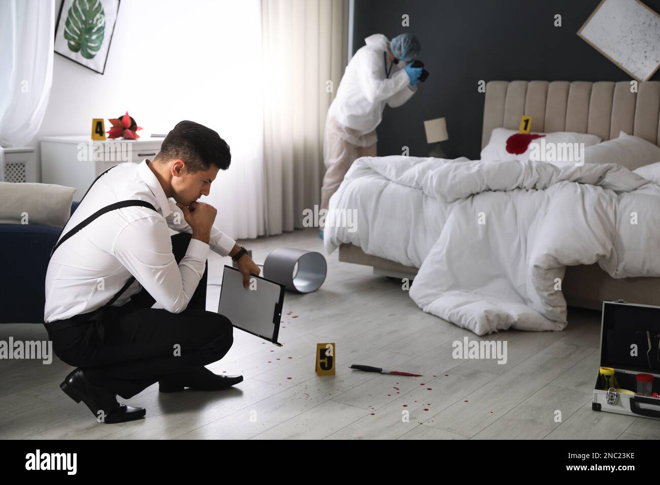 Investigators working at crime scene in messy room Stock Photo - Alamy