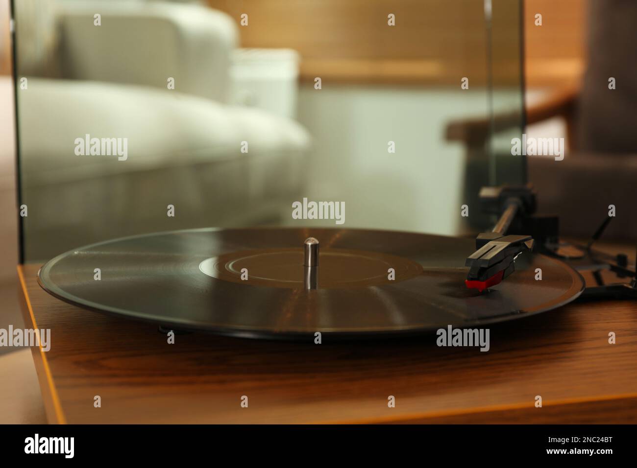 Modern vinyl record player with disc on table indoors, closeup Stock ...