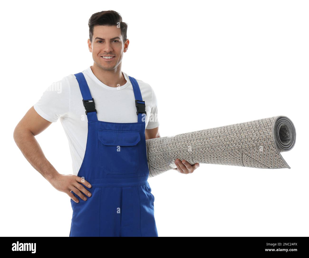 Male worker with rolled carpet on white background Stock Photo - Alamy