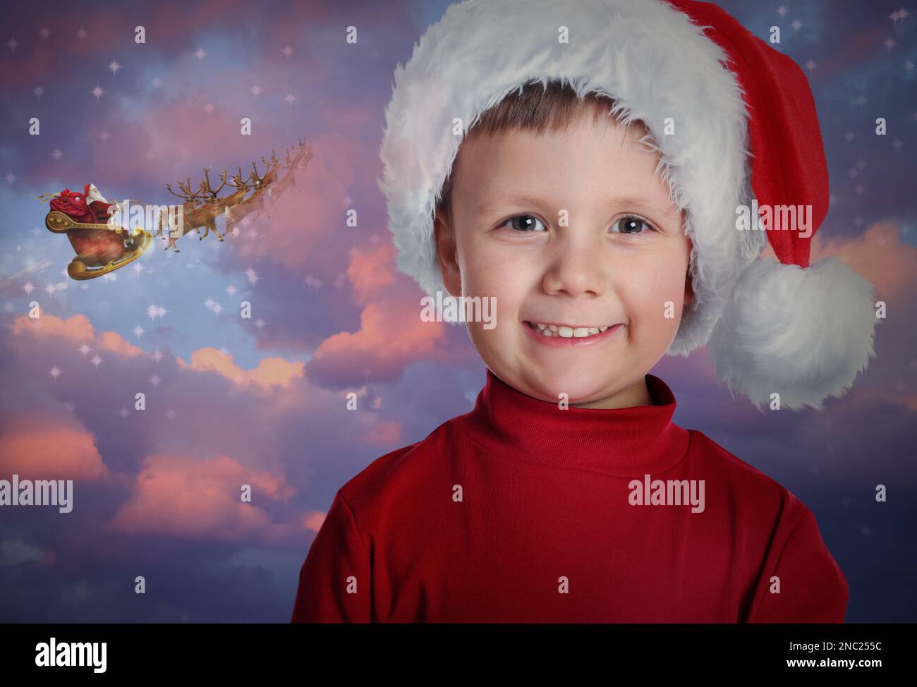 Cute little child and Santa Claus flying in his sleigh on background ...