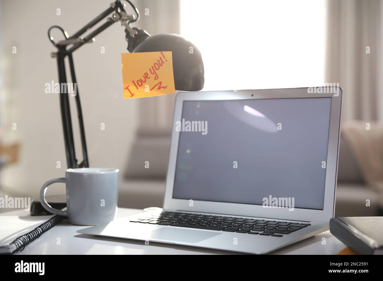 Sticky note with handwritten text I Love You attached to lamp at ...