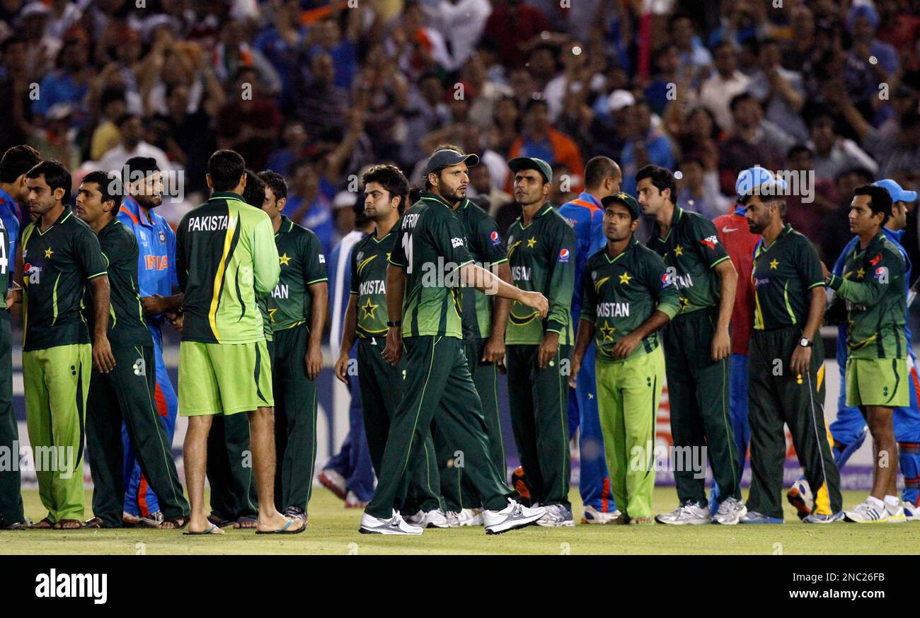 Pakistan captain Shahid Afridi, center, walks after congratulating ...