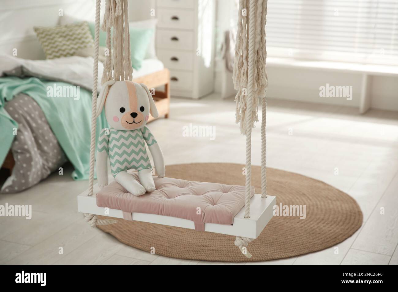 Stylish swing with toy in child's room. Interior design Stock Photo - Alamy