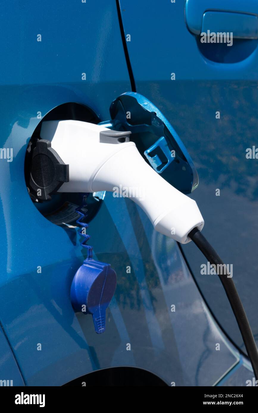 Electric Car blue Charging on street parking Stock Photo - Alamy