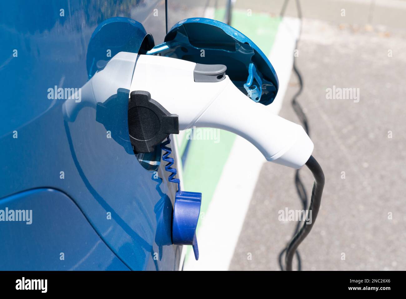 Electric blue car vehicle charging on street parking power supply ...