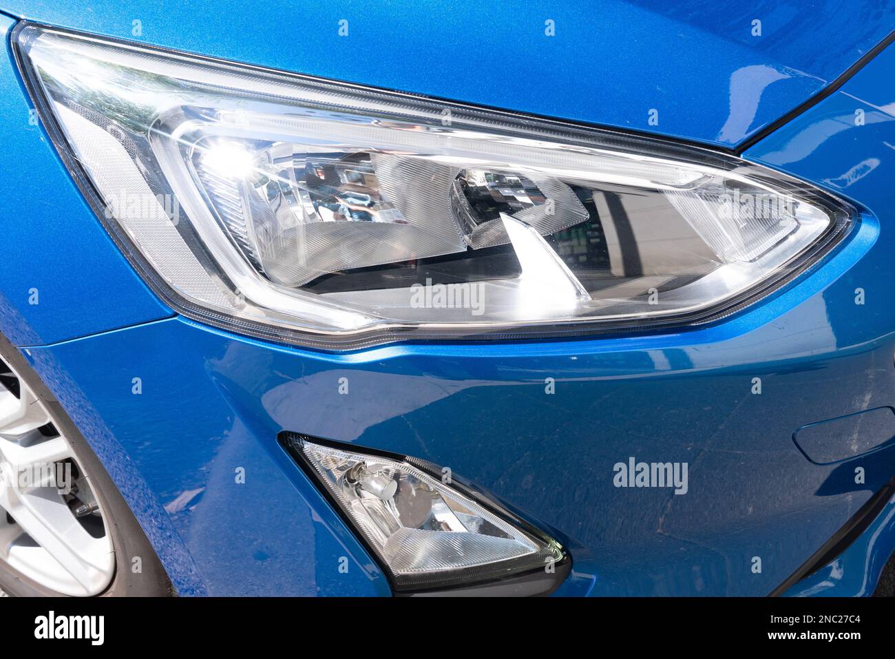 headlight detail of modern blue luxury car with projector lens for low ...
