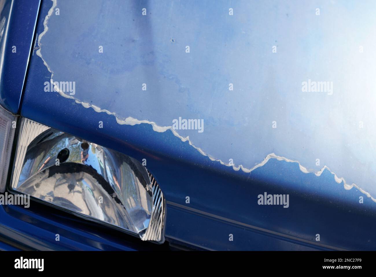 front hood blue car with damaged and peeled paint protective lacquer in ...