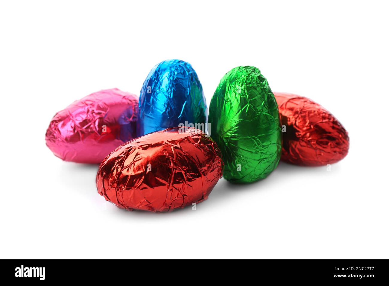 Chocolate eggs wrapped in bright foil on white background Stock Photo ...