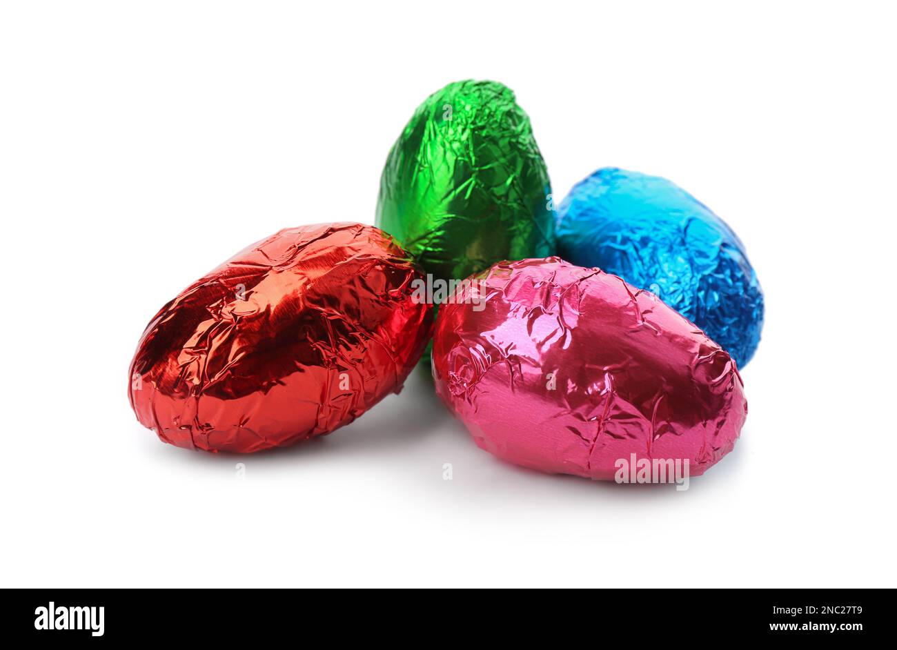 Chocolate eggs wrapped in bright foil on white background Stock Photo ...