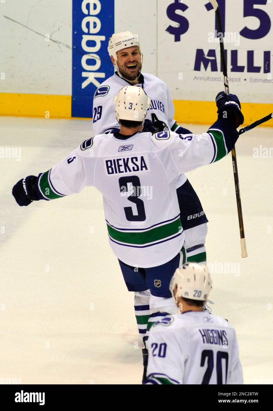 Vancouver Canucks defenseman Aaron Rome (29) is congratulated by ...